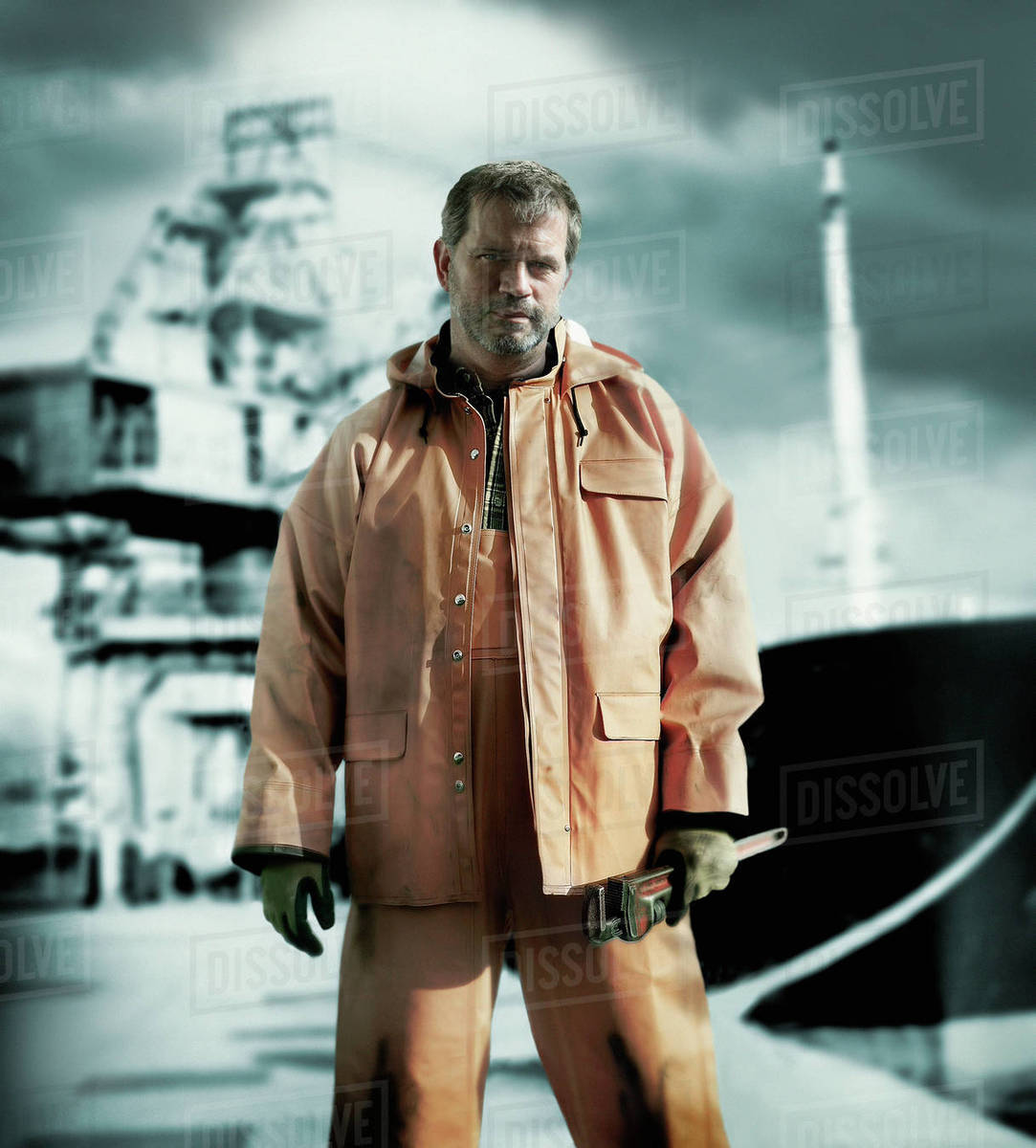 Serious Caucasian worker holding wrench on oil rig - Stock Photo - Dissolve