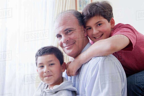 Smiling Hispanic father and sons - Royalty-free Stock Photo | Dissolve