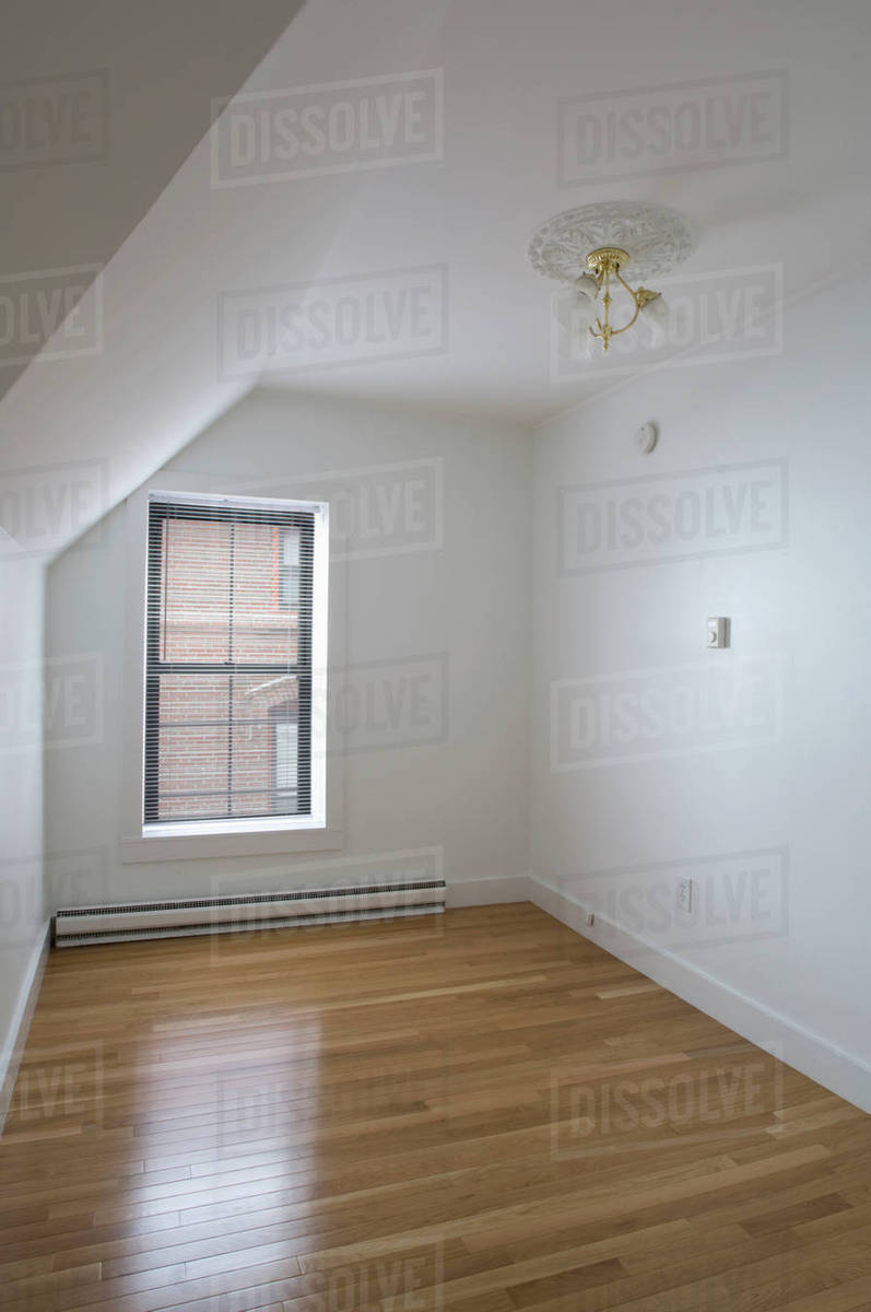 Empty room in apartment with hardwood floor - Stock Photo - Dissolve