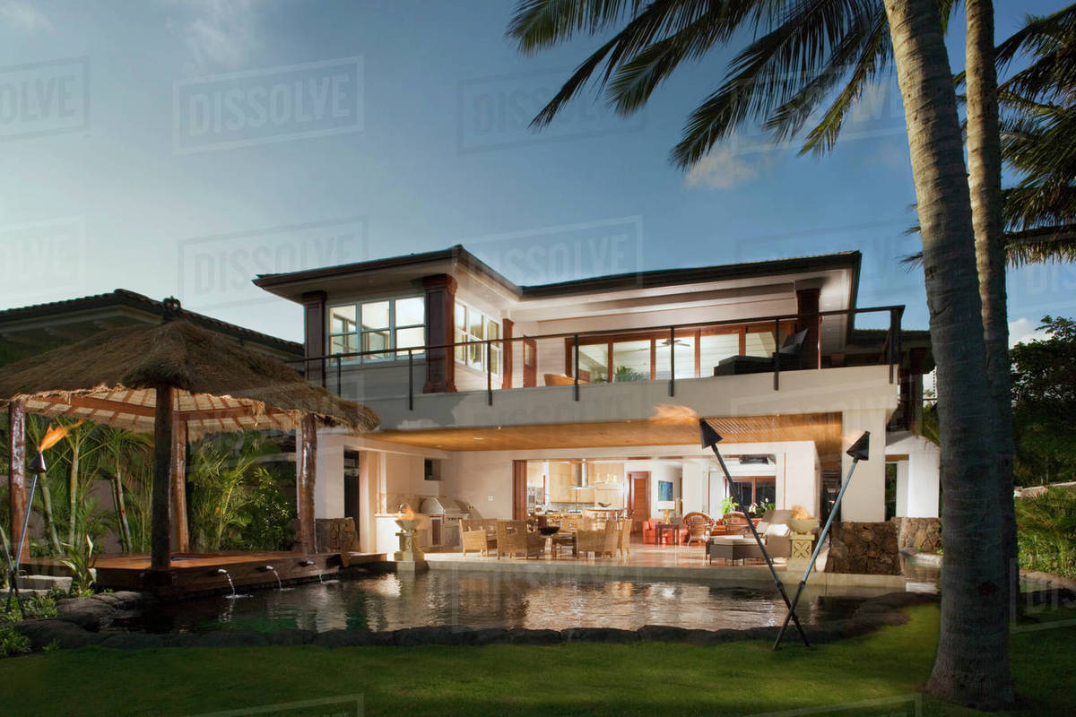 Modern Hawaiian home with pocket doors and wrap around balcony - Stock ...