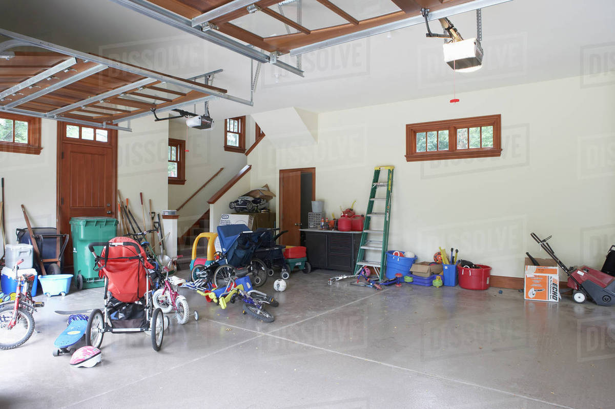 Messy garage filled with toys and sporting equipment, before new ...