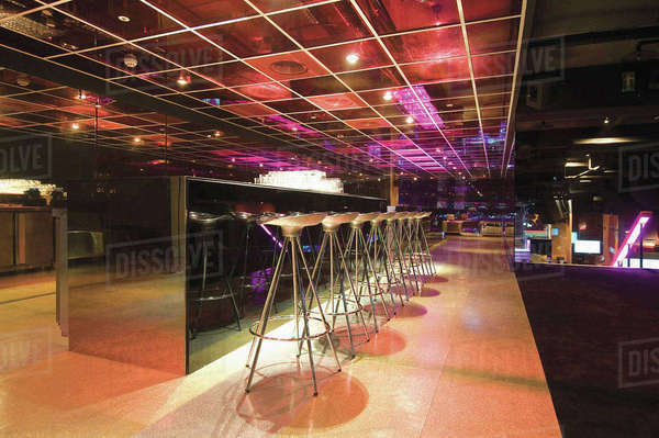 Bar counter with stools in modern nightclub - Royalty-free Stock Photo ...