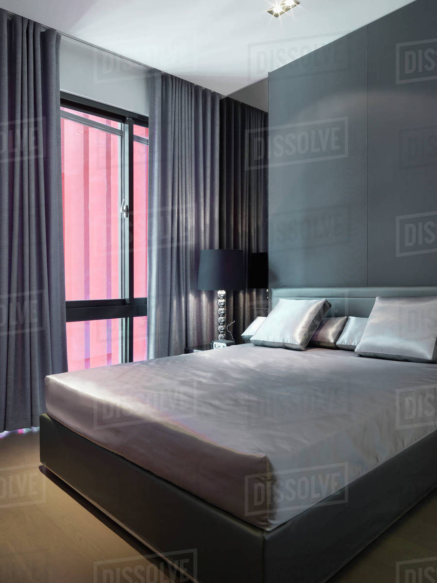 Simple bed with satin sheets - Royalty-free Stock Photo | Dissolve