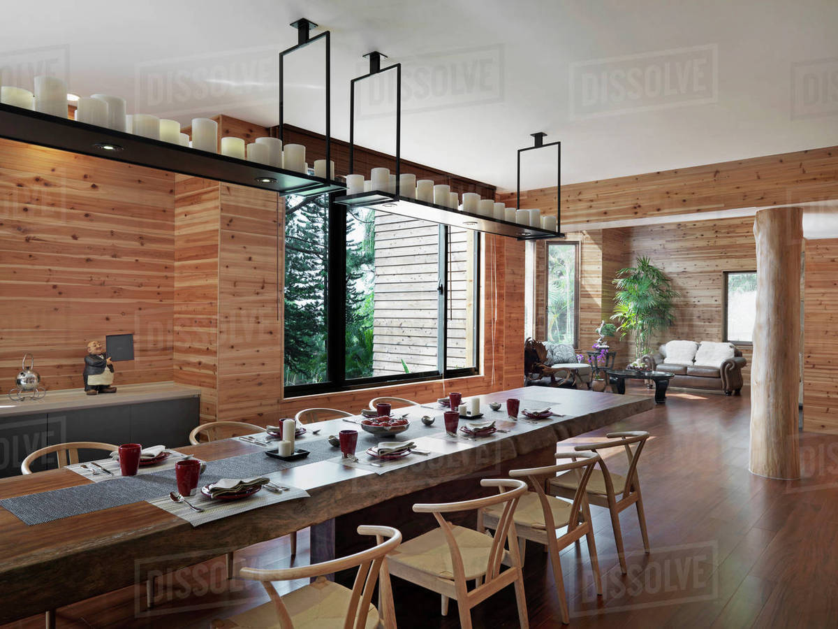 Large wooden dining table in cabin home - Stock Photo - Dissolve