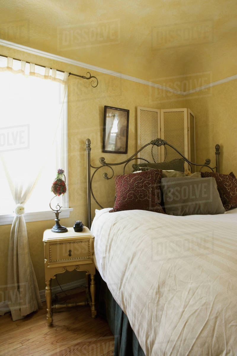 Vignette of naturally lit bedroom. - Royalty-free Stock Photo | Dissolve