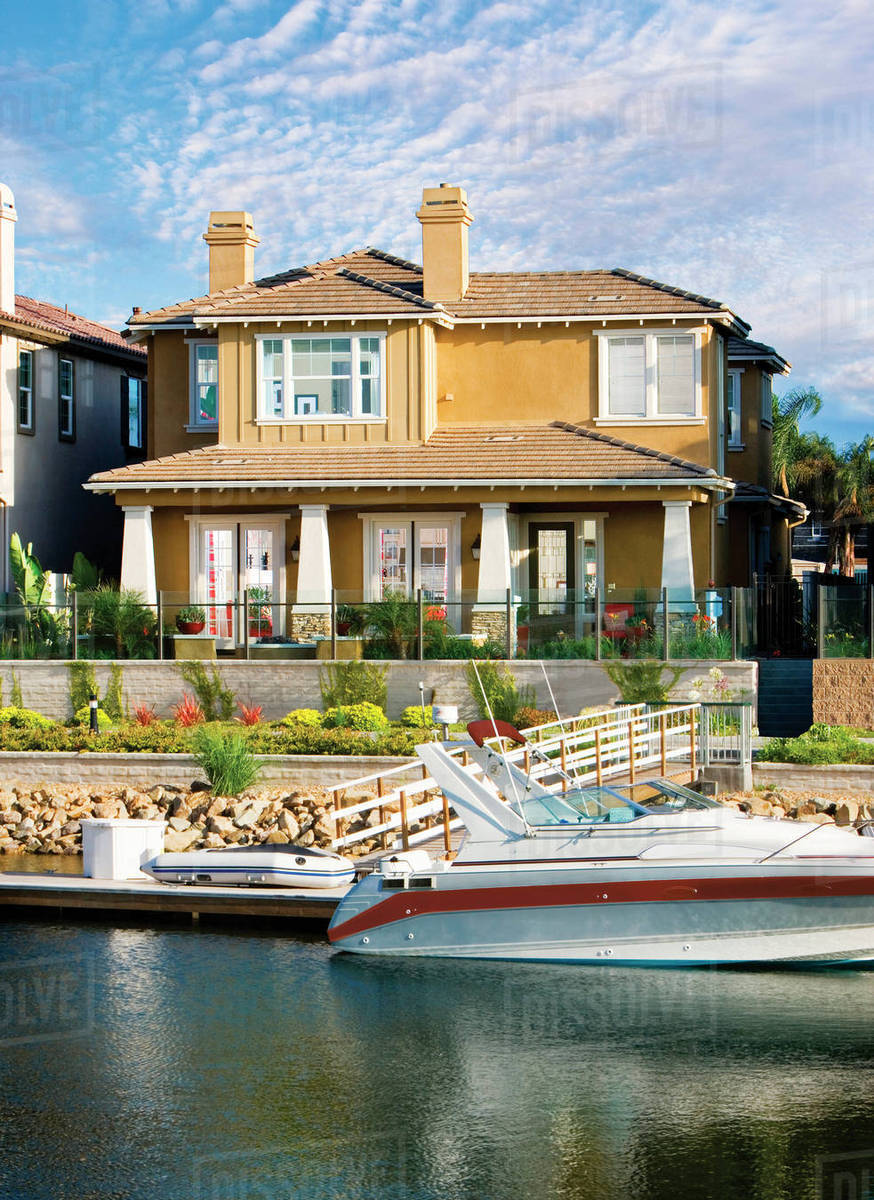 Exterior of one story house with speedboat in lake - Royalty-free Stock ...
