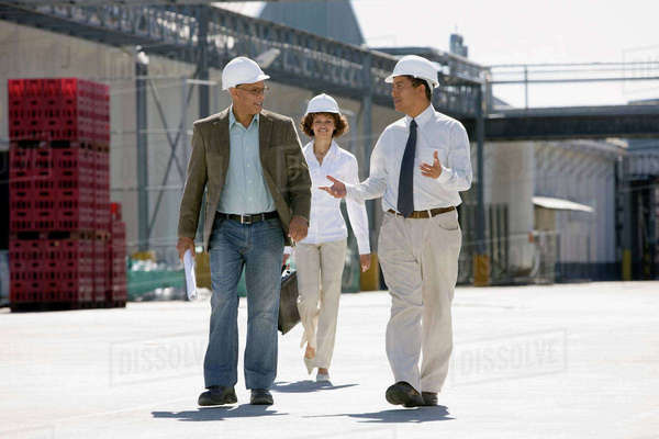 Business people walking outside factory - Royalty-free Stock Photo ...