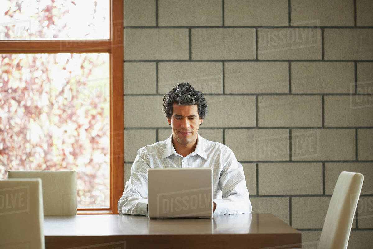 Man typing on laptop - Stock Photo - Dissolve