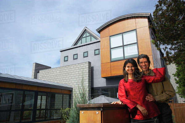 Couple hugging in front of modern house - Royalty-free Stock Photo ...