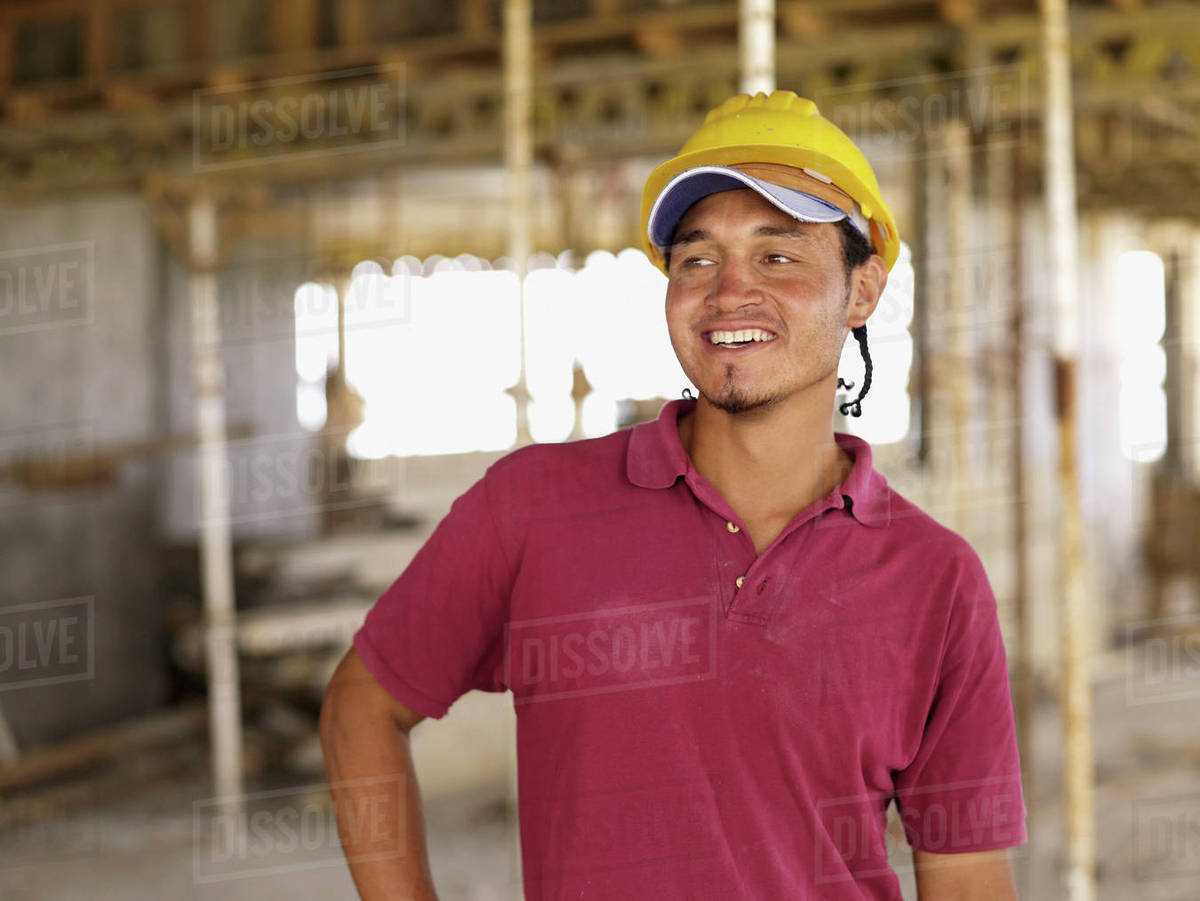 Hispanic worker smiling on construction site - Royalty-free Stock Photo ...