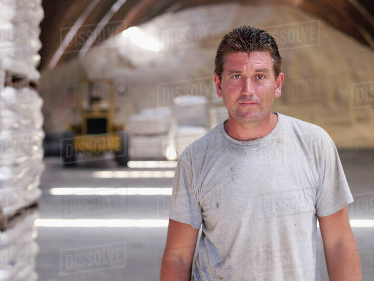 Hispanic worker in factory warehouse - Royalty-free Stock Photo | Dissolve