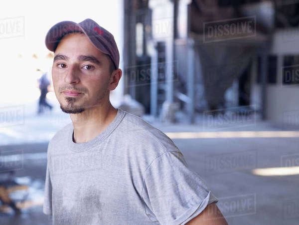 Hispanic worker in factory - Stock Photo - Dissolve