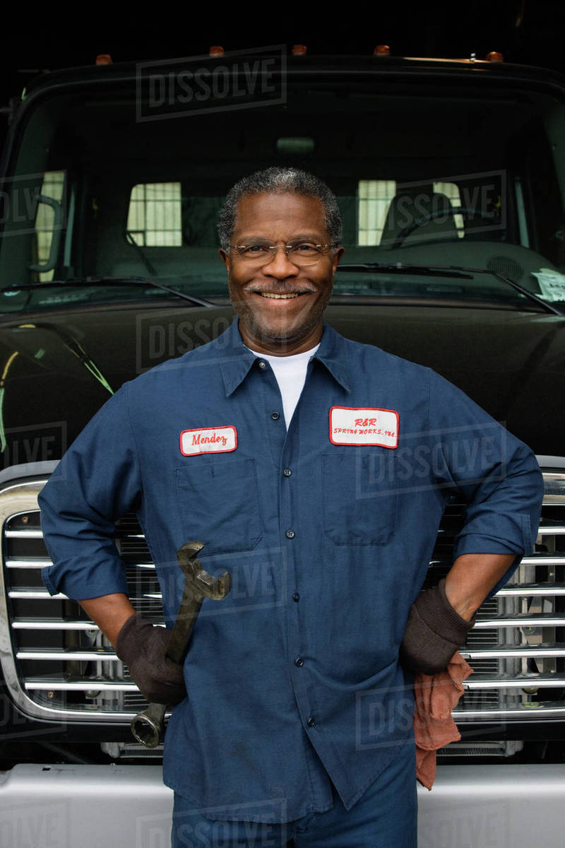 African mechanic standing in front of truck - Royalty-free Stock Photo ...