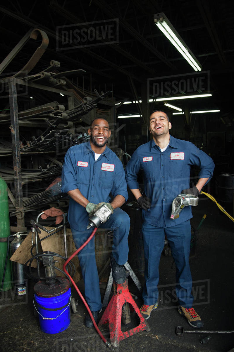 Mechanics working together in repair shop - Royalty-free Stock Photo ...