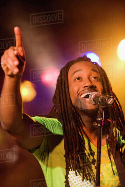 African man singing onstage - Royalty-free Stock Photo | Dissolve