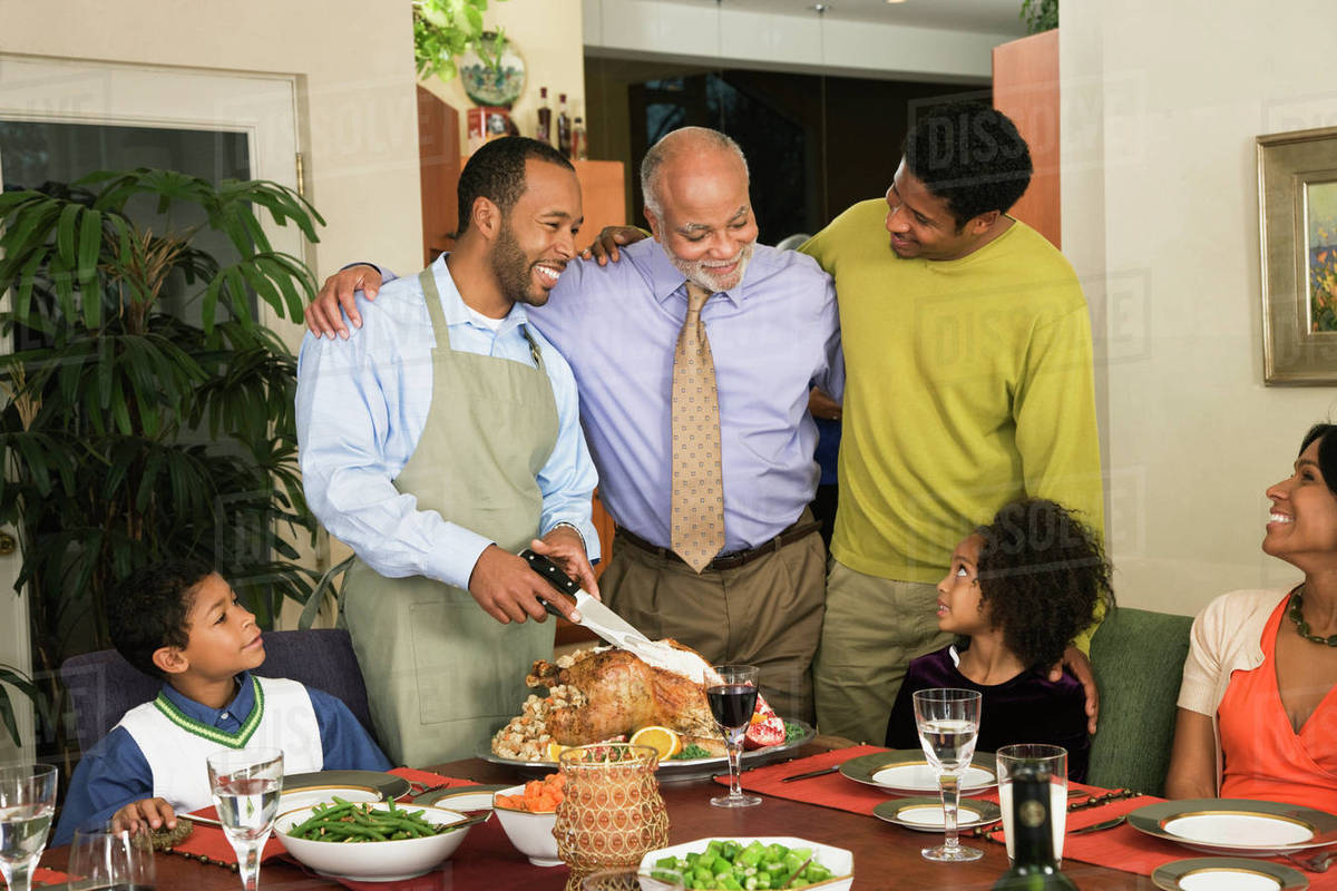 African American man carving Thanksgiving turkey - Royalty-free Stock ...