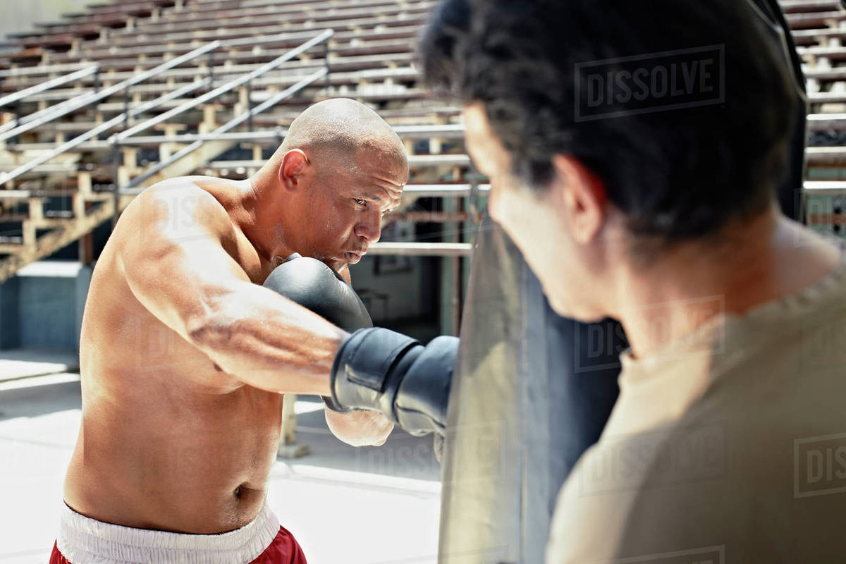 Hispanic boxer training in gym - Stock Photo - Dissolve