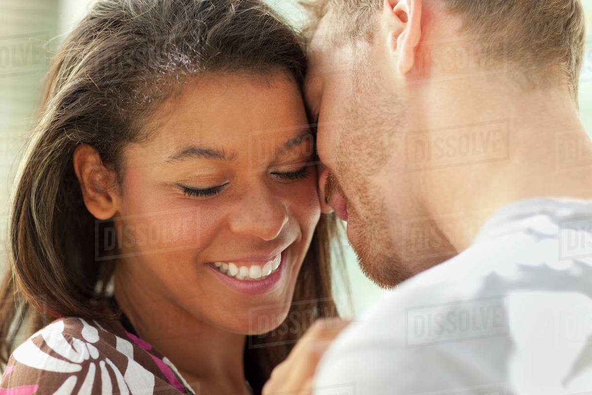Smiling couple hugging outdoors - Royalty-free Stock Photo | Dissolve