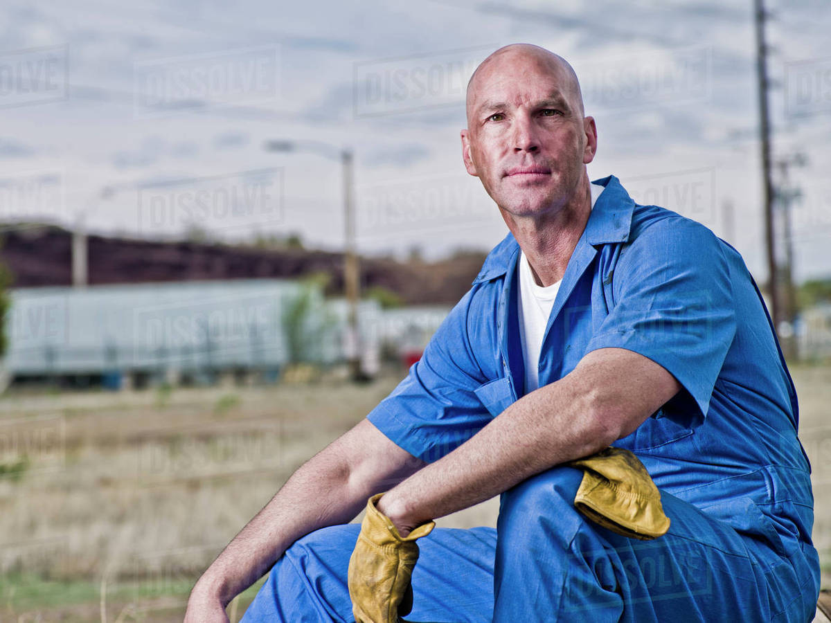 Serious mechanic in coveralls relaxing - Royalty-free Stock Photo ...