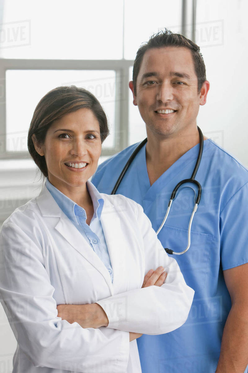 Smiling doctors standing together - Royalty-free Stock Photo | Dissolve
