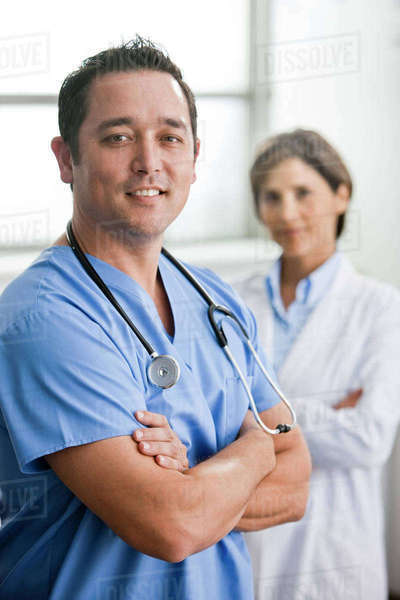 Smiling doctors standing together - Royalty-free Stock Photo | Dissolve
