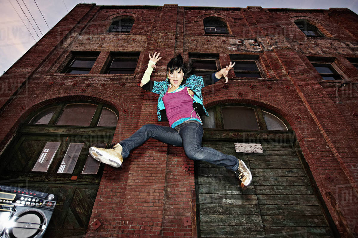 Chinese woman breakdancing in urban area - Royalty-free Stock Photo ...