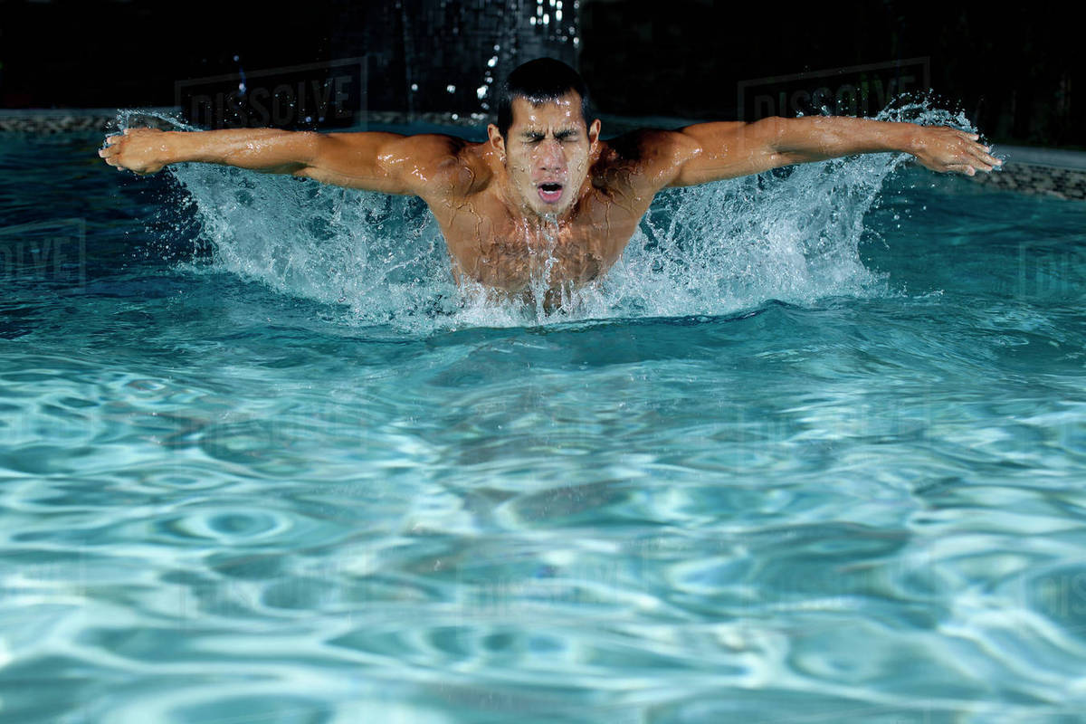 Pacific Islander man swimming in swimming pool - Royalty-free Stock ...
