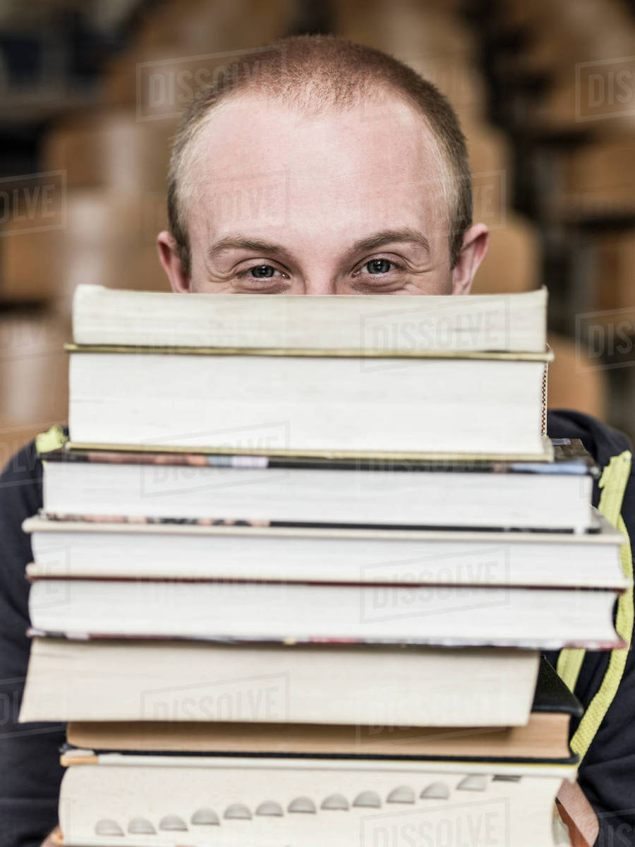 Caucasian student holding stack of books - Royalty-free Stock Photo ...