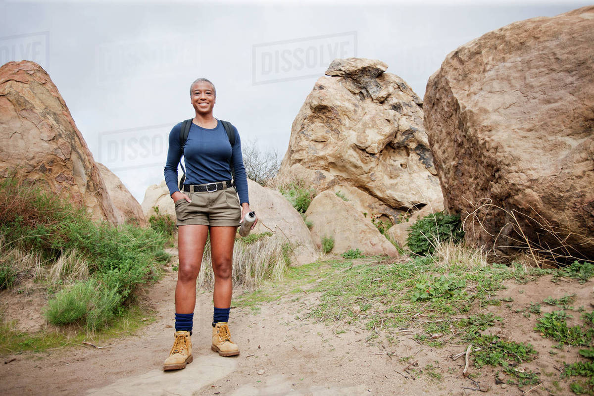 Black woman hiking in remote area - Royalty-free Stock Photo | Dissolve