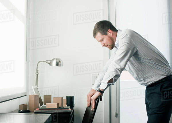 Caucasian businessman leaning on chair - Royalty-free Stock Photo ...