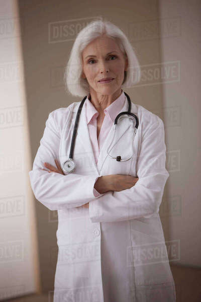 Caucasian doctor standing with arms crossed - Royalty-free Stock Photo ...