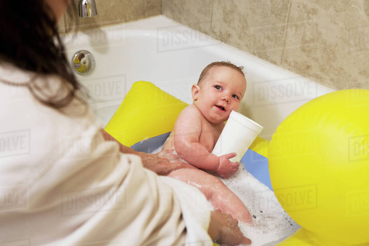 Caucasian mother bathing baby boy - Stock Photo - Dissolve