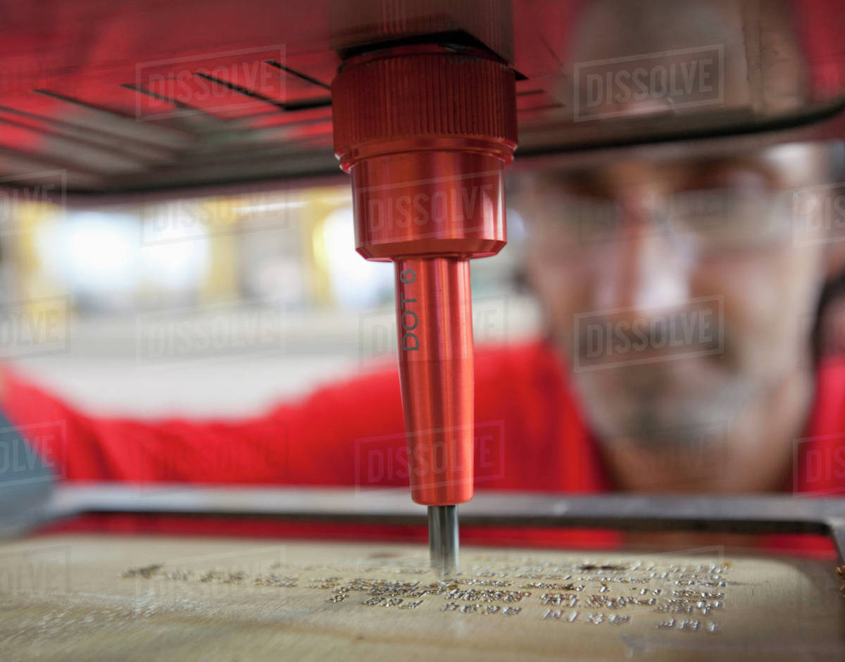 Caucasian worker using branding machine in factory - Royalty-free Stock ...