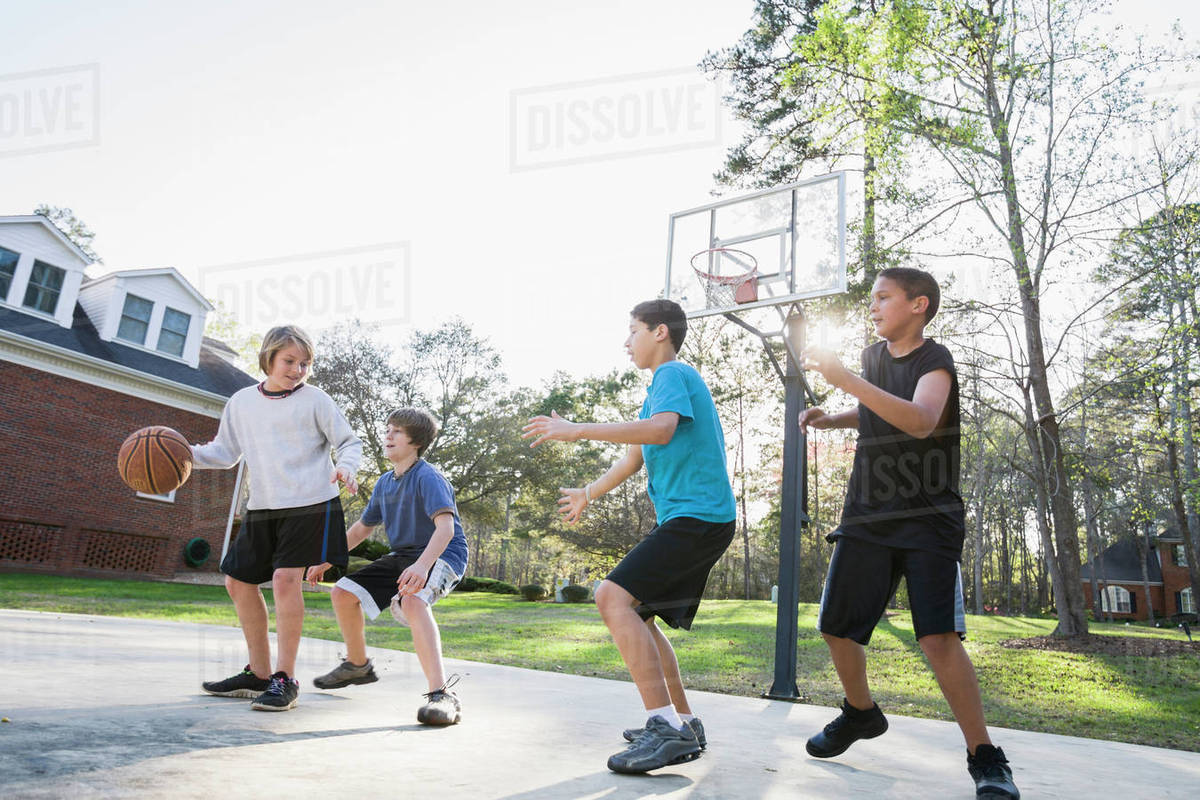 Boys playing basketball - Royalty-free Stock Photo | Dissolve