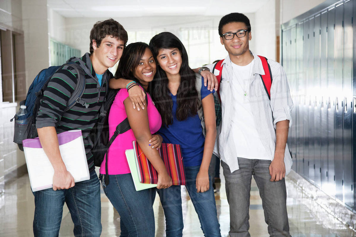 High school friends standing in corridor together - Stock Photo - Dissolve