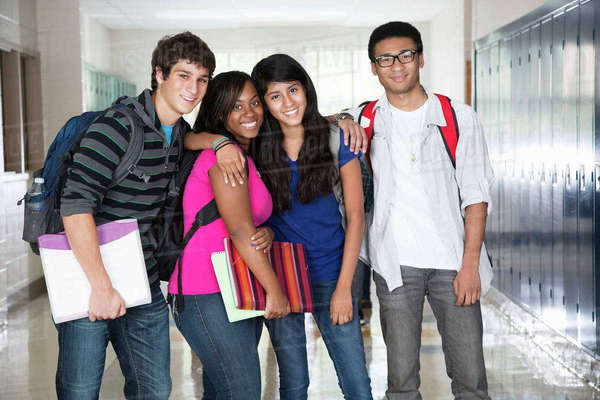 High school friends standing in corridor together - Stock Photo - Dissolve