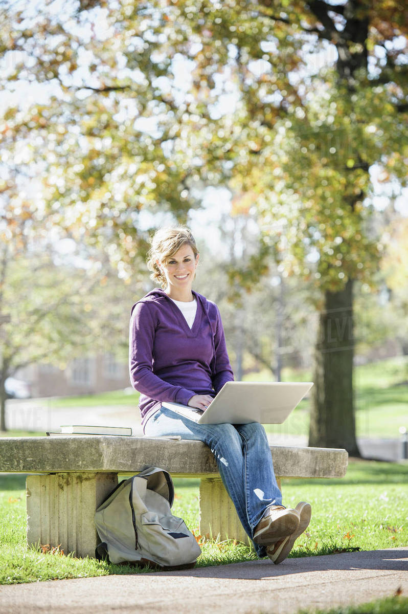 Caucasian student using laptop on campus - Royalty-free Stock Photo ...