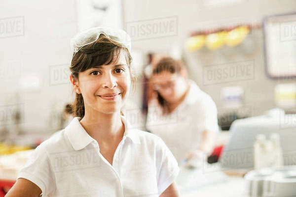 Worker smiling in manufacturing plant - Royalty-free Stock Photo | Dissolve