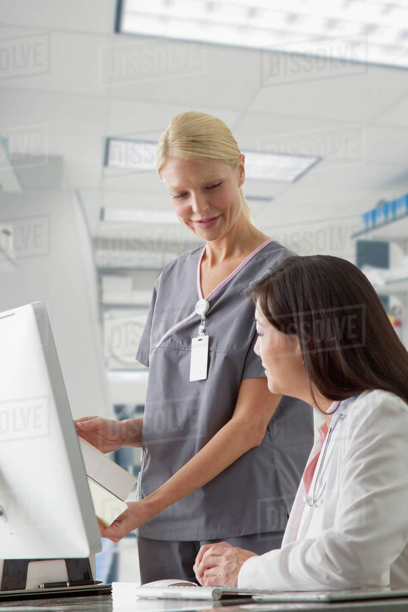 Doctor and nurse working at computer in hospital - Royalty-free Stock ...