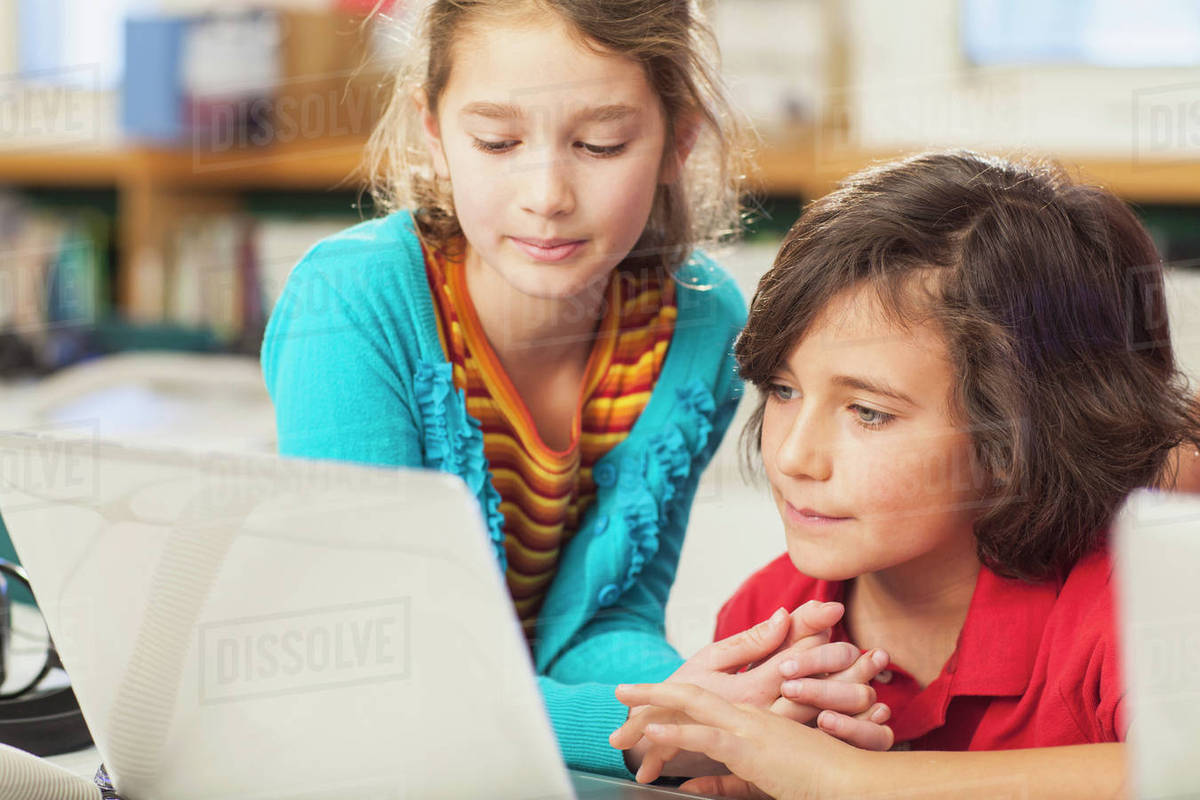 Caucasian children using laptop in library - Royalty-free Stock Photo ...