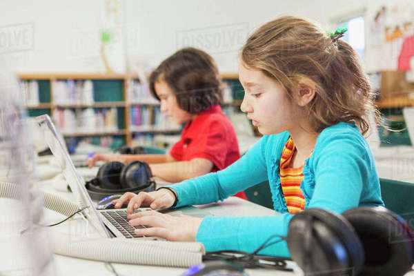 Caucasian children using laptops in library - Royalty-free Stock Photo ...