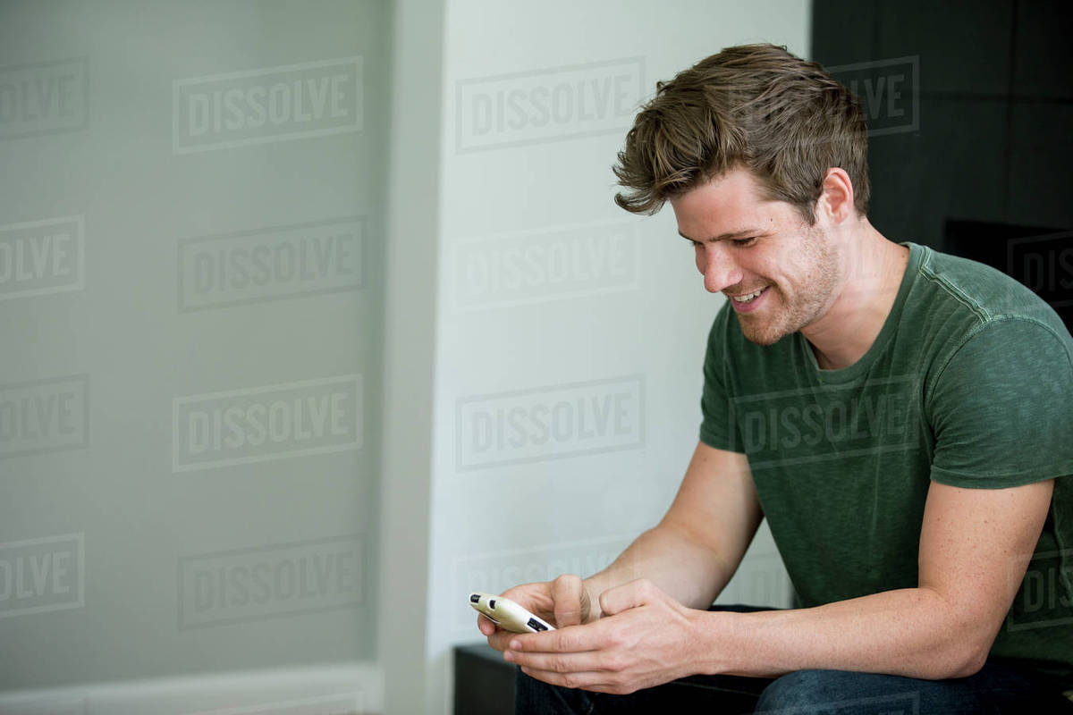 Man using cell phone - Stock Photo - Dissolve