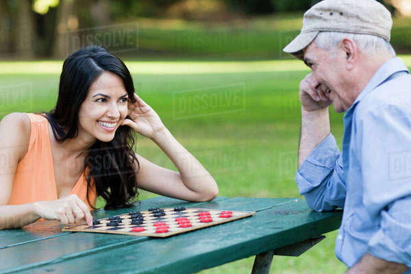 Hispanic father and daughter playing checkers - Royalty-free Stock ...