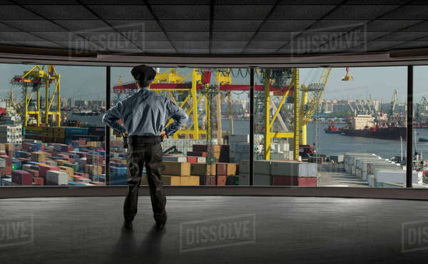 Police officer overlooking shipyard - Royalty-free Stock Photo | Dissolve