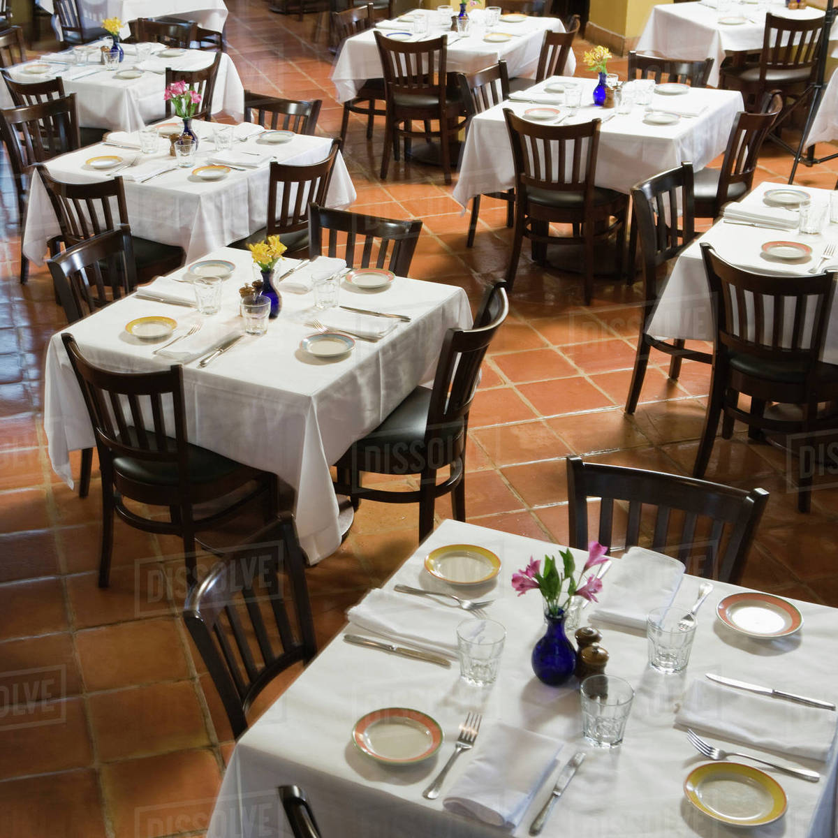 Tables and chairs in empty restaurant - Stock Photo - Dissolve