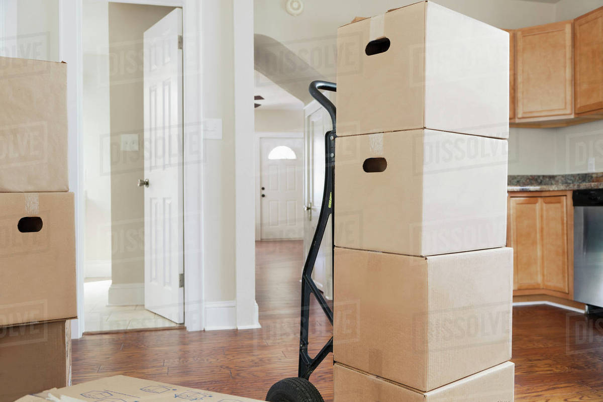 Boxes and cartons stacked in a house - Royalty-free Stock Photo | Dissolve