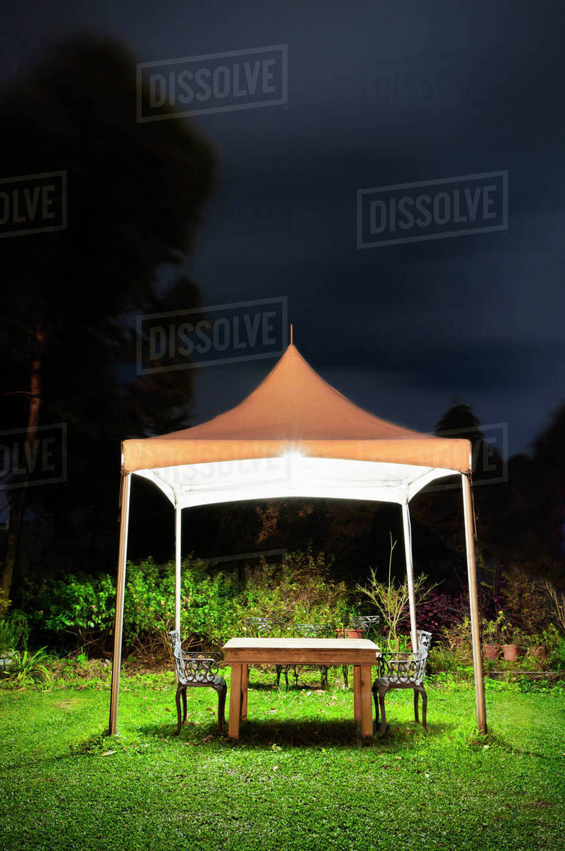 Illuminated canopy and table in garden - Royalty-free Stock Photo ...