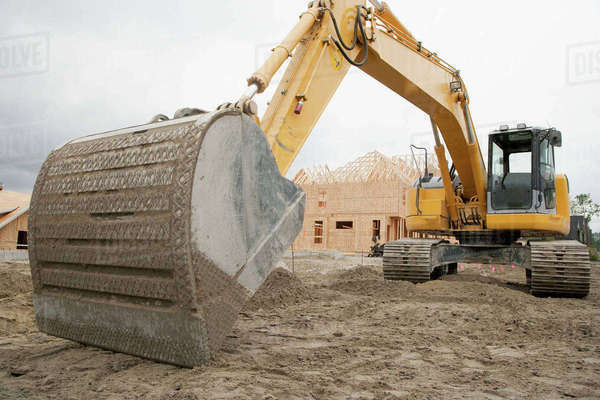Bulldozer breaking ground at construction site - Stock Photo - Dissolve