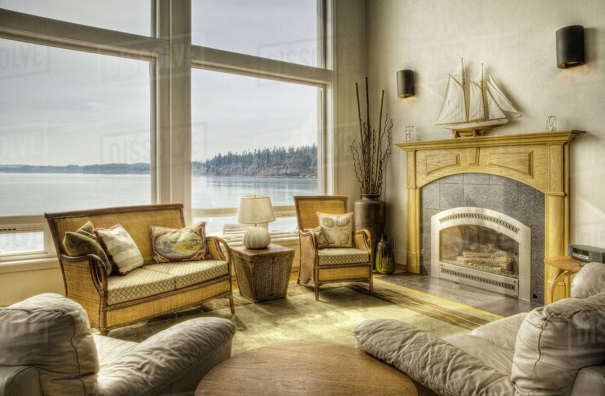 Luxury living room overlooking lake - Stock Photo - Dissolve