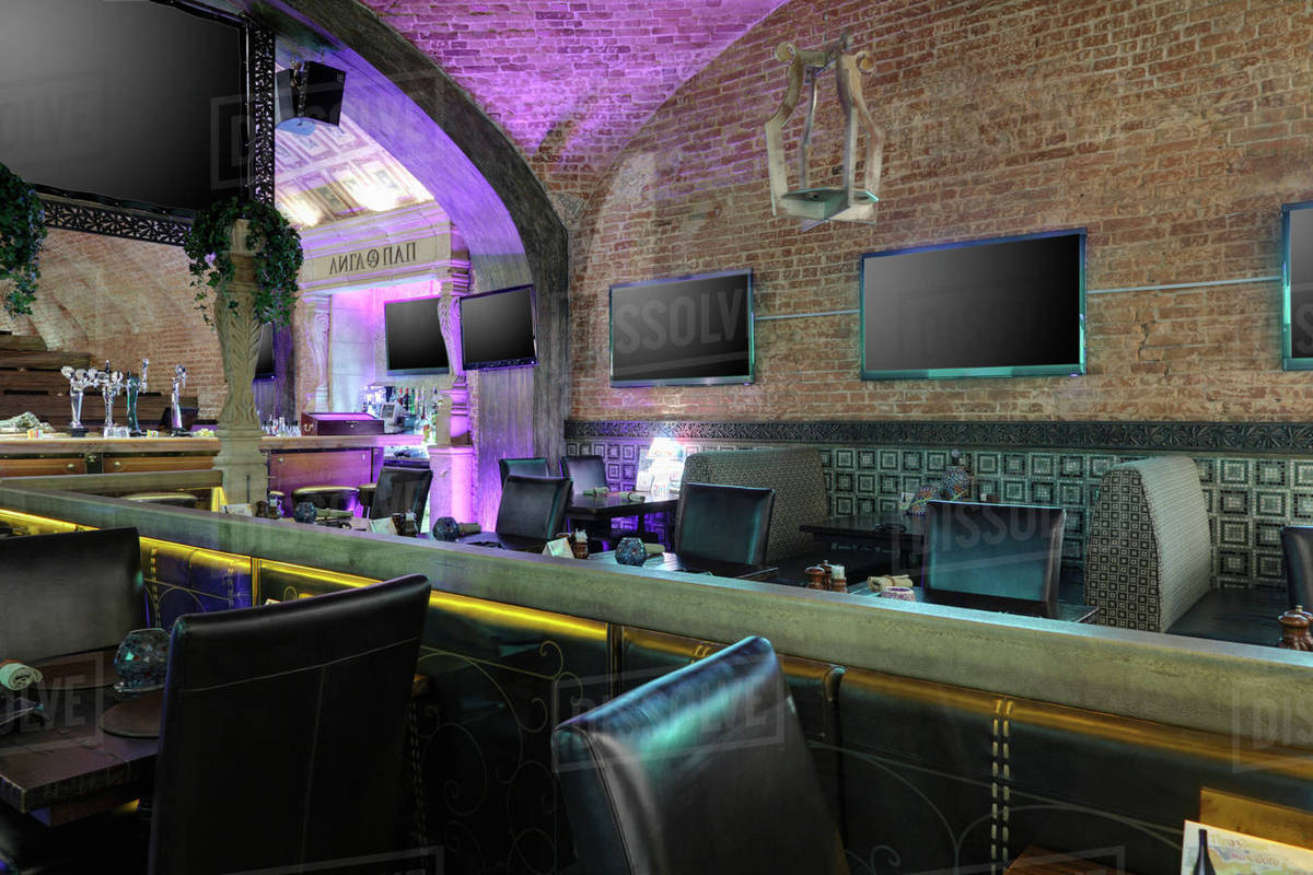 Raw of TV screens on restaurant wall - Royalty-free Stock Photo | Dissolve